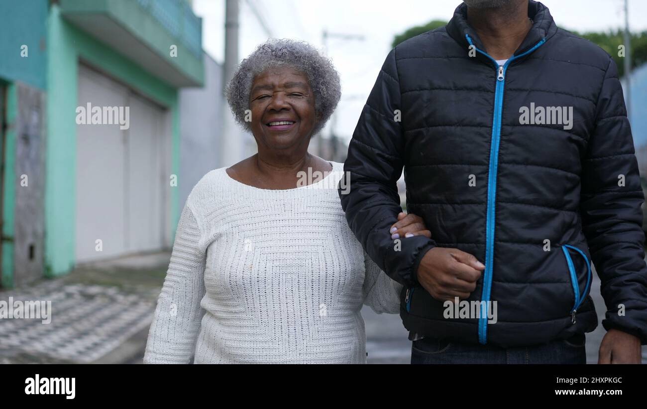 Generational relationship father and 80s mother walking together in ...