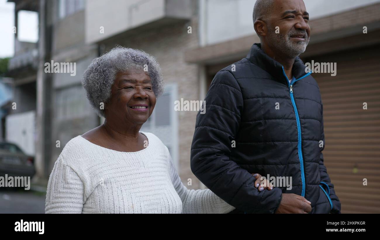 Generational relationship father and 80s mother walking together in ...