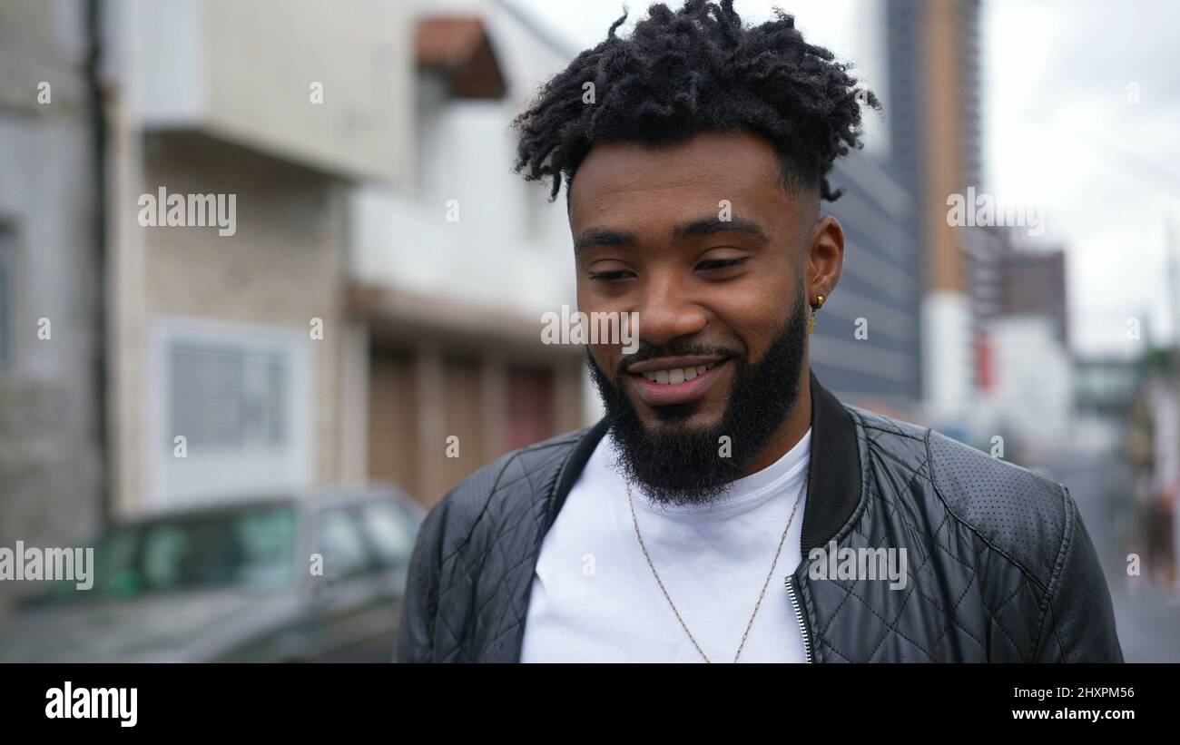One young man walking outside in urban street person walks forward ...