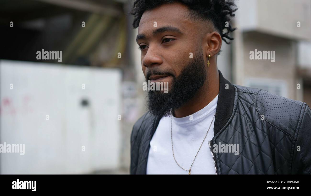 One young man walking outside in urban street person walks forward ...