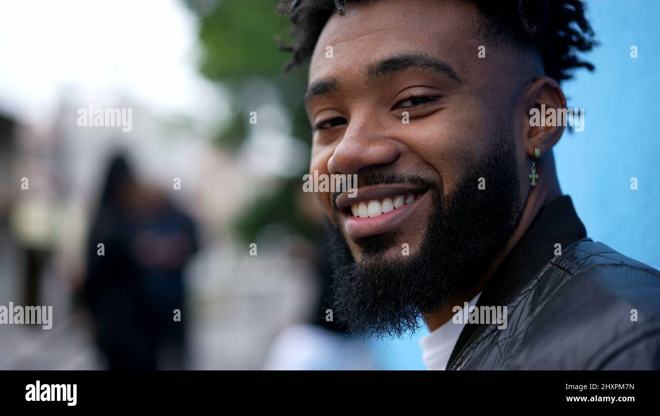 Portrait of a black man smiling at camera close-up face an African ...