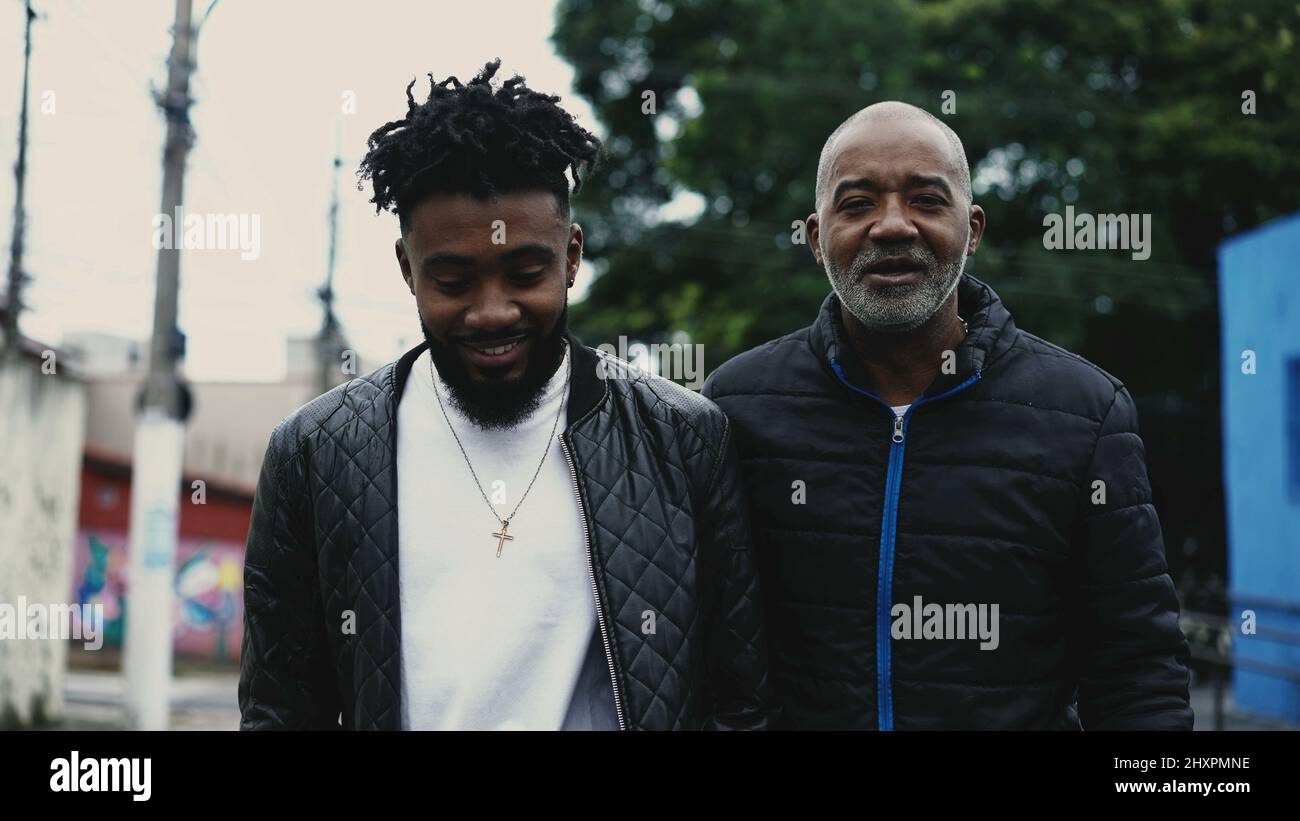 Two Brazilian father and son walking together in street Stock Photo - Alamy