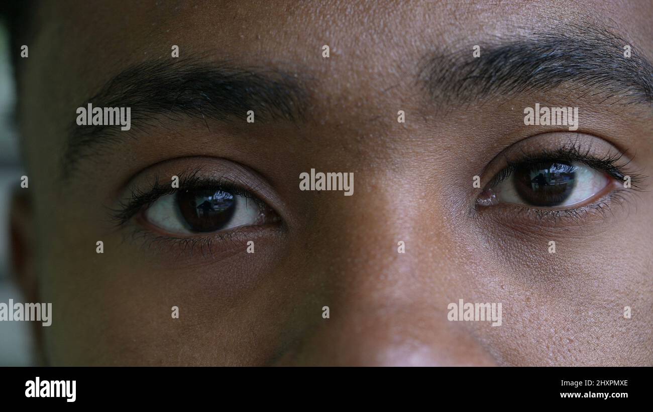 A black man eyes close-up looking at camera an african person macro ...