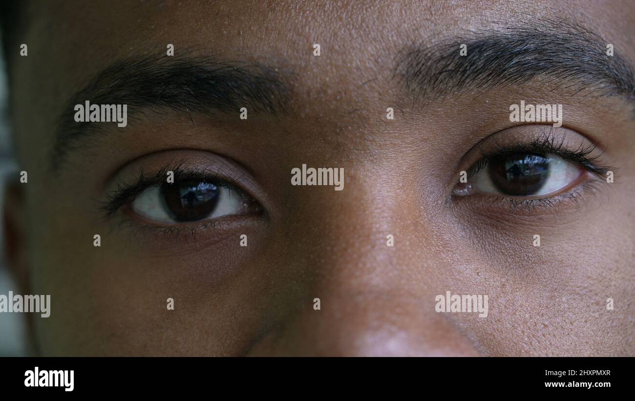 A black man eyes close-up looking at camera an african person macro ...
