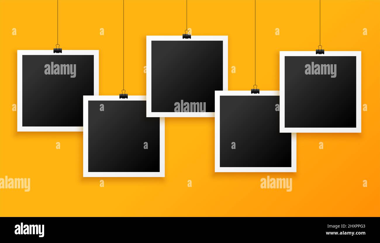 five hanging photo frames on yellow background Stock Photo - Alamy