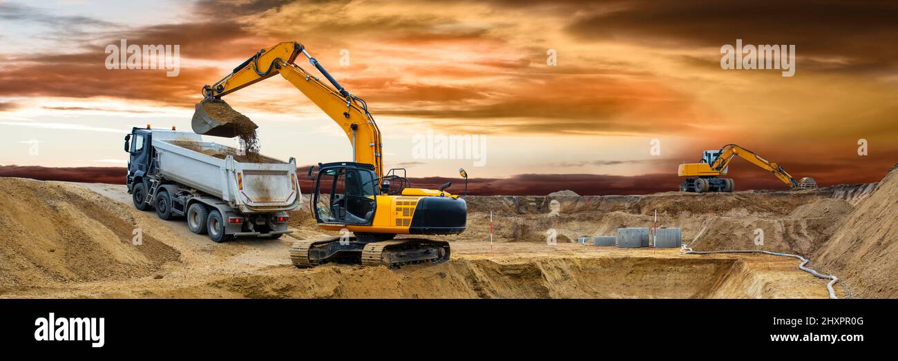 earth mover and excavator at work in construction site Stock Photo - Alamy