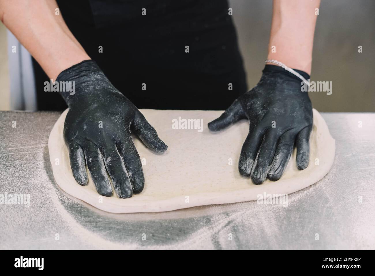 Preparation of a homemade Italian style pizza by a specialist Stock ...