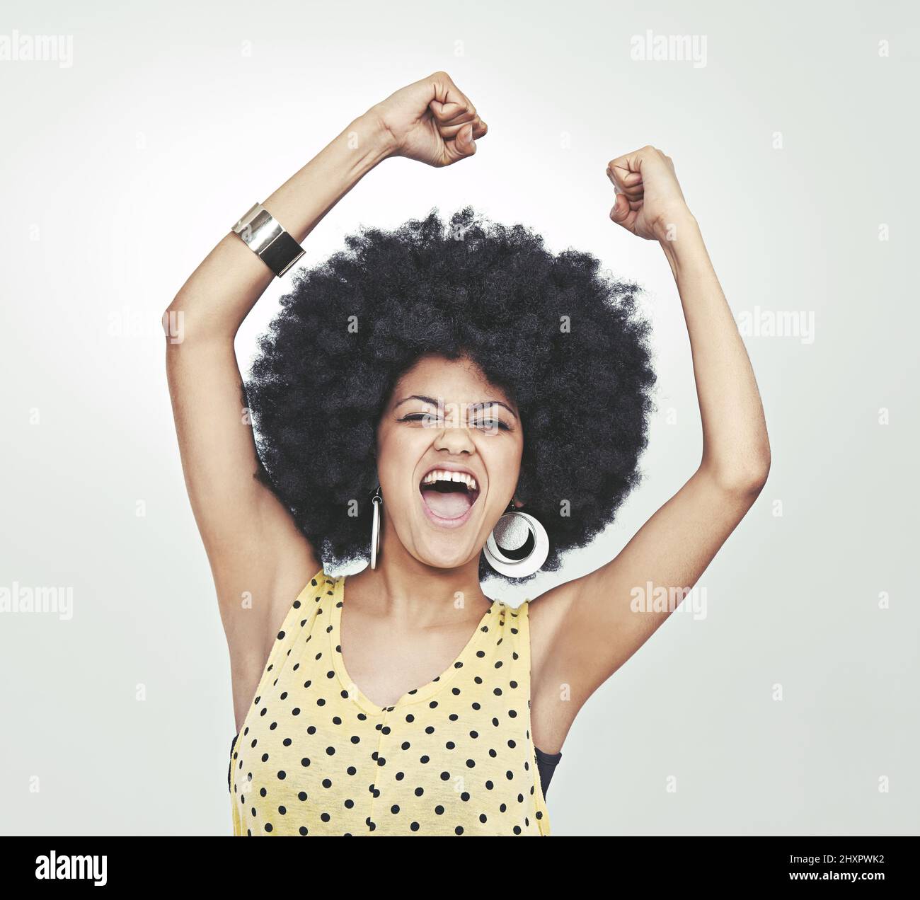 Freak out. Studio shot of a young woman in a retro outfit shouting with ...