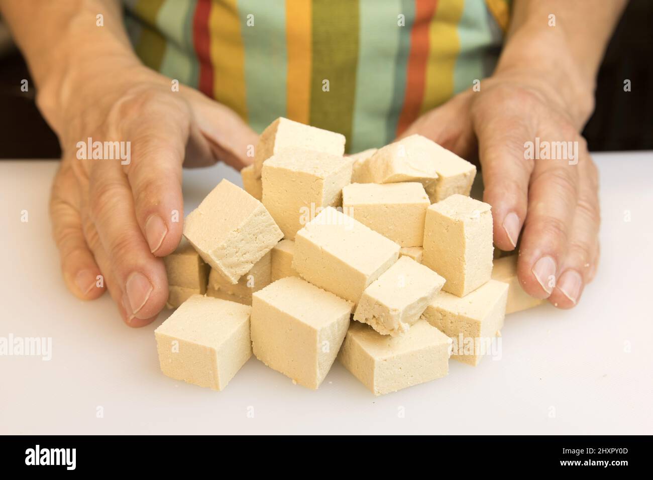 a person in the kitchen wearing a green apron prepares the meal by ...