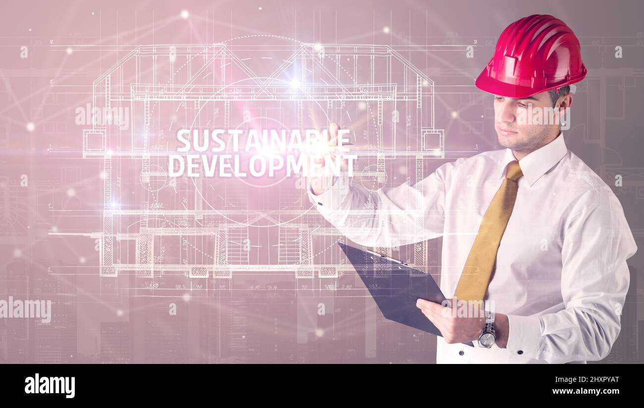 Handsome architect drawing with helmet Stock Photo - Alamy