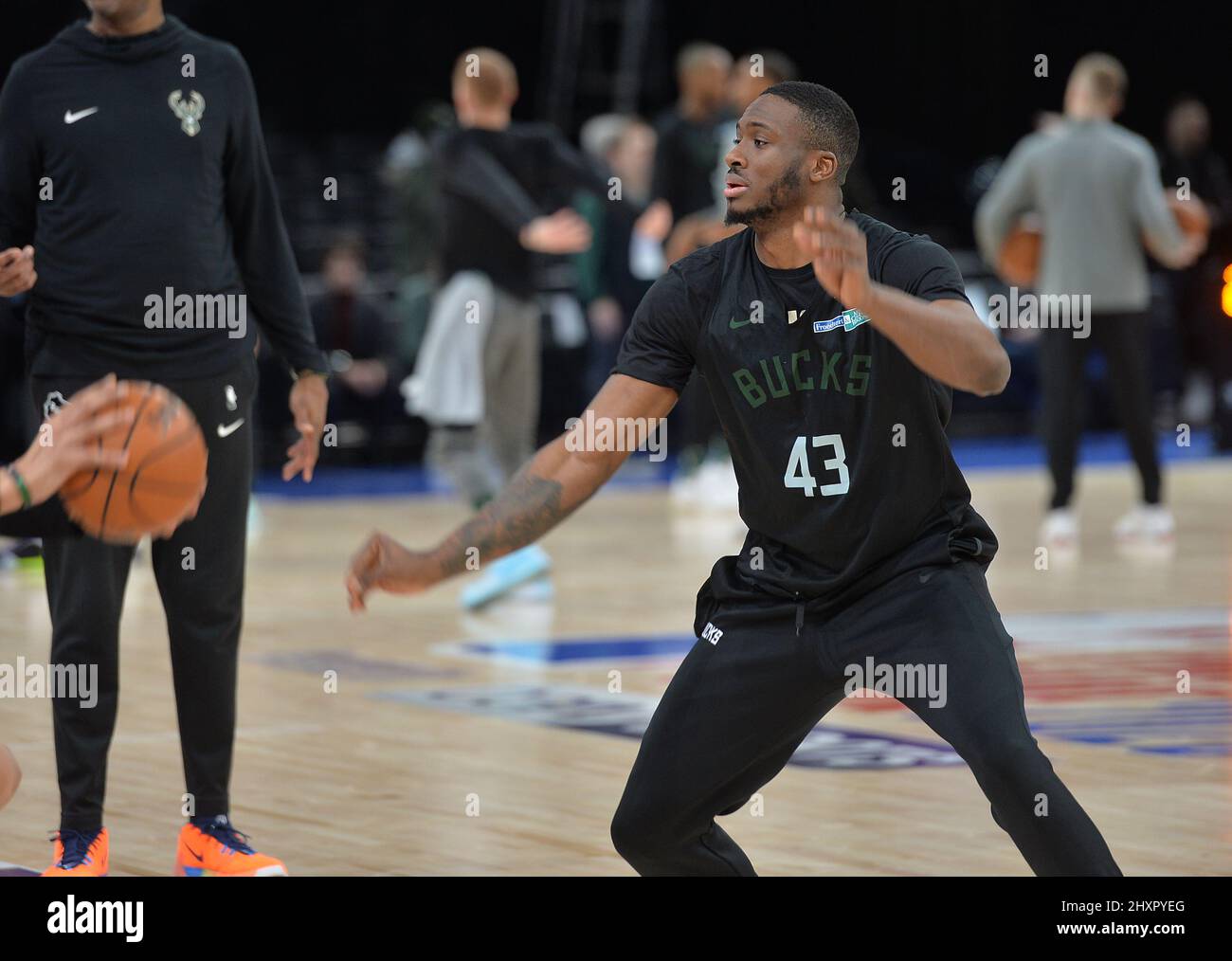 Giannis Antetokounmpo #34 and teammate of the Milwaukee Bucks shoots ...
