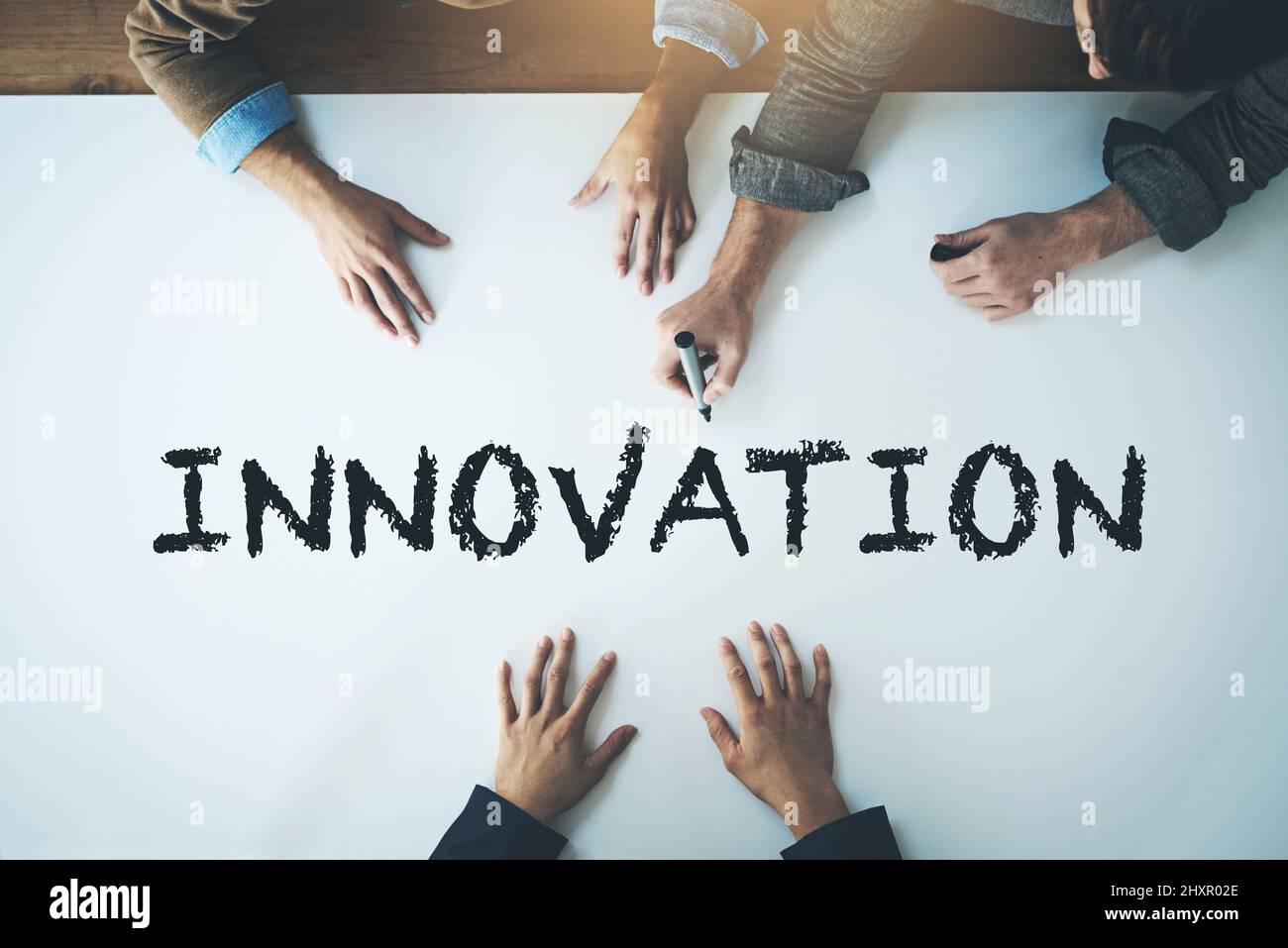 Innovation is change that unlocks new value. Studio shot of a group of ...