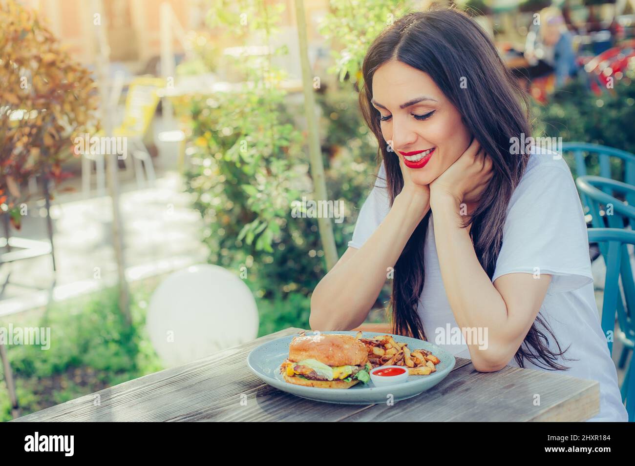 Beautiful woman eating burger closeup hi-res stock photography and ...