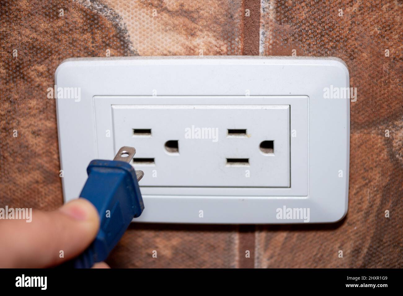 Hand pulling electrical plug from household power outlet isolated Stock ...