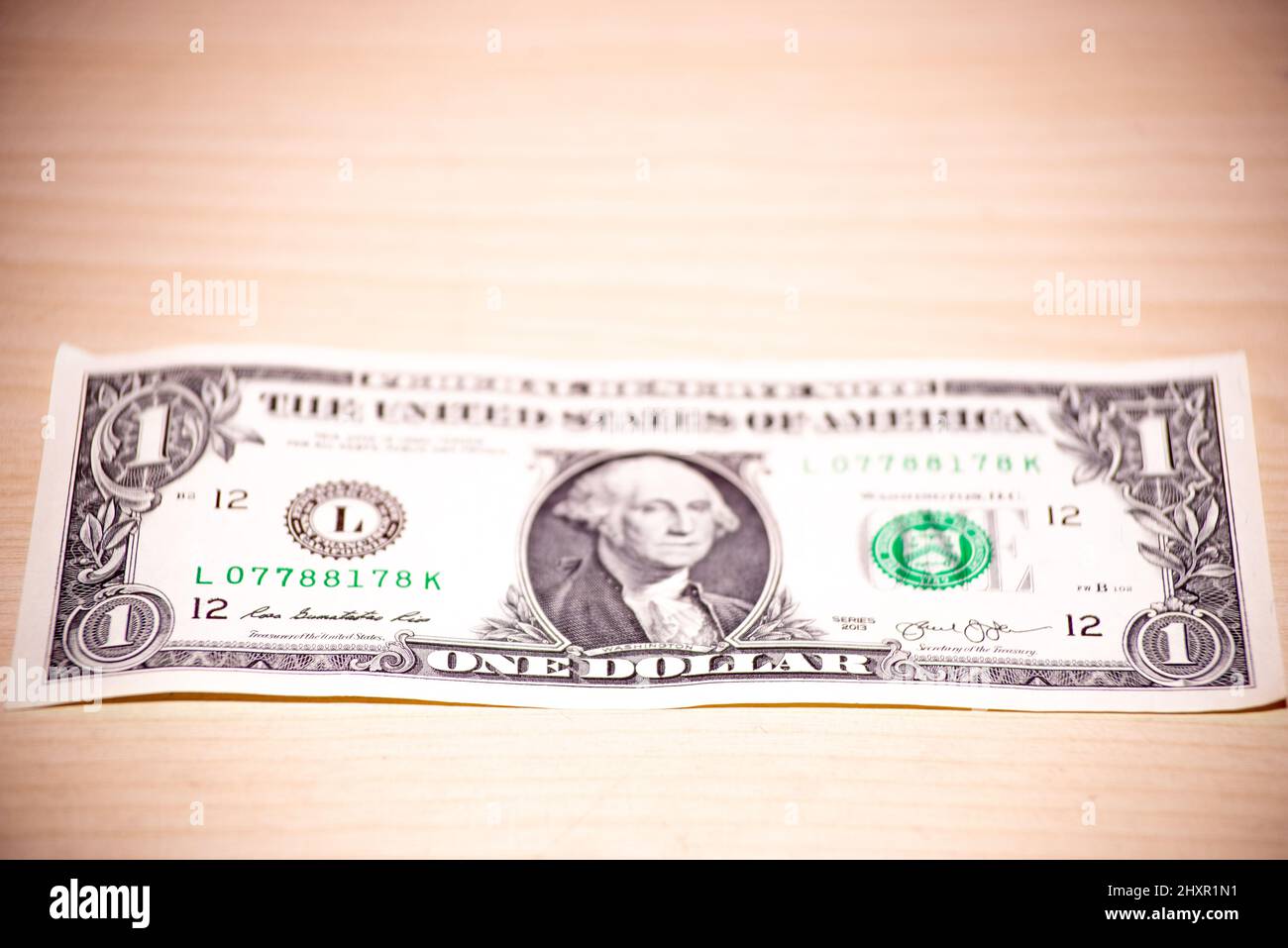 One US dollar bill in a wood table. Us banknote Stock Photo - Alamy