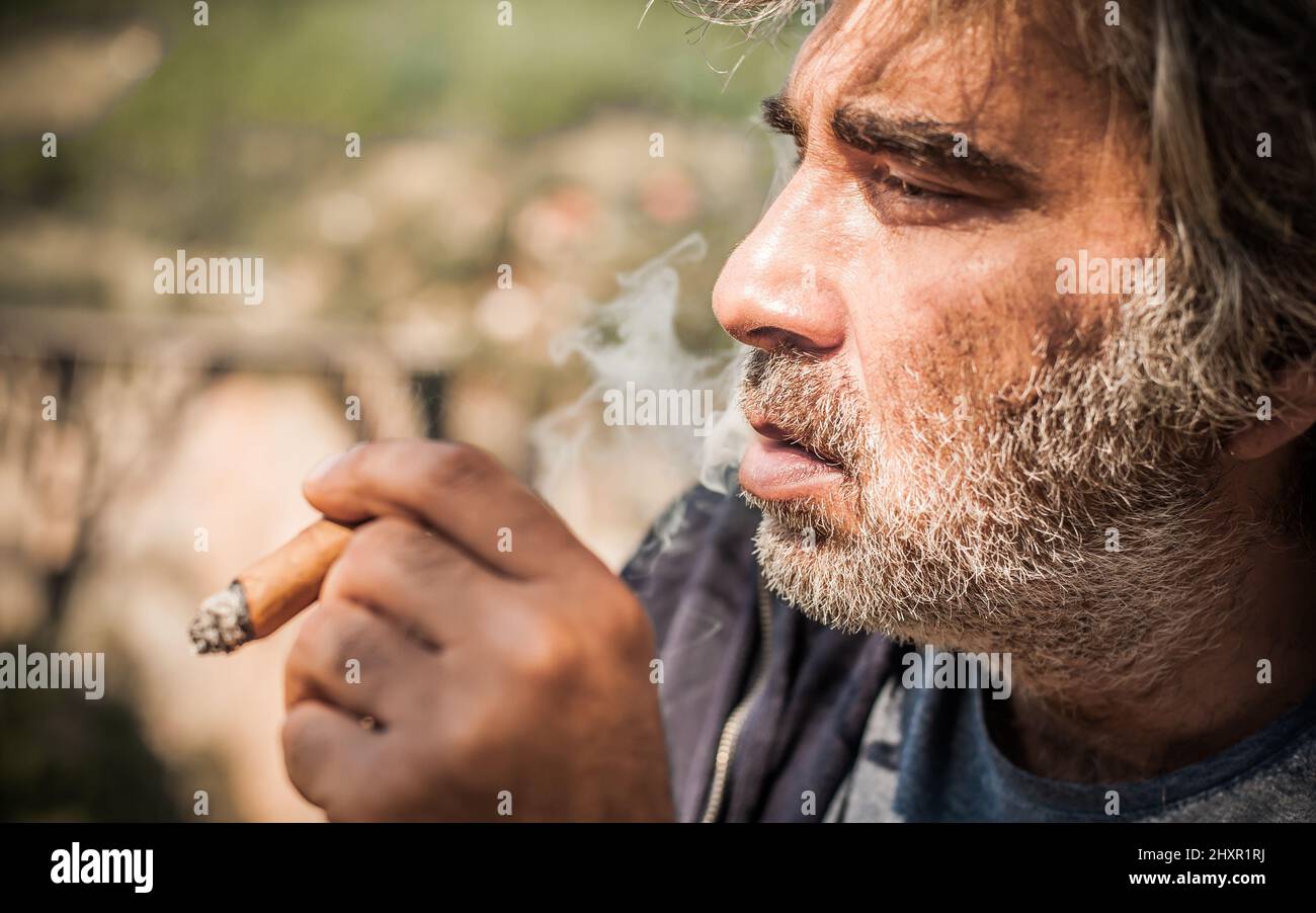 Bearded man smoking cigar outdoor hi-res stock photography and images ...