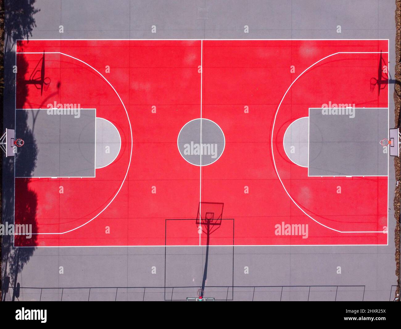 Partial overhead drone view of a red and gray basketball court Stock ...