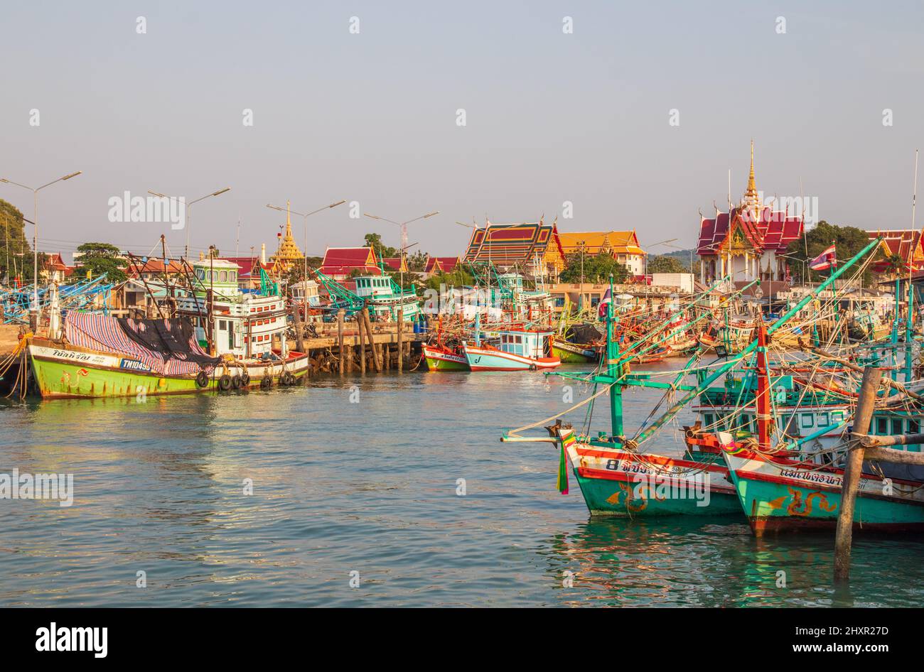 Thai fishing boats at a pier near a te Stock Photo - Alamy