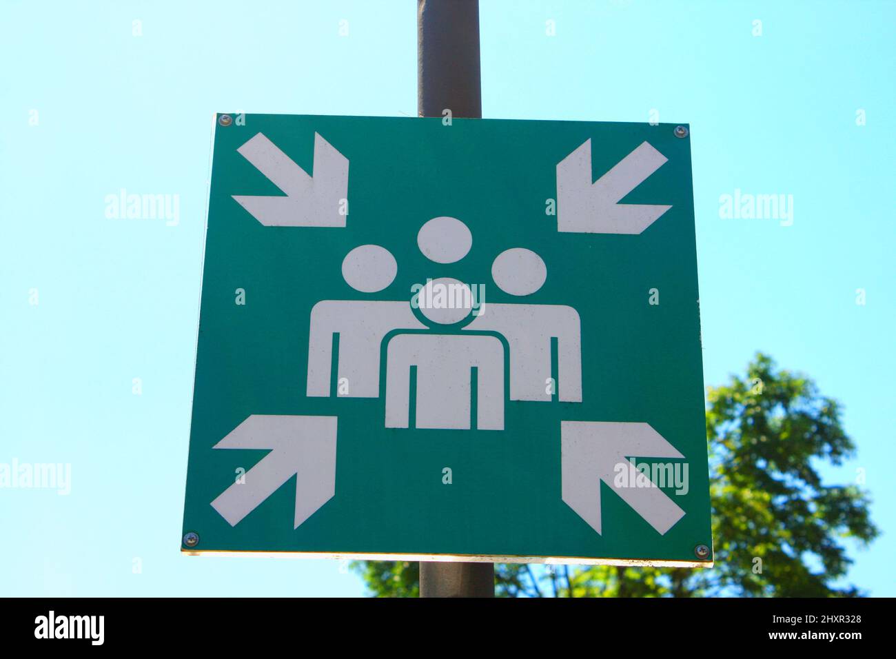 Green assembly point sign on street Stock Photo - Alamy