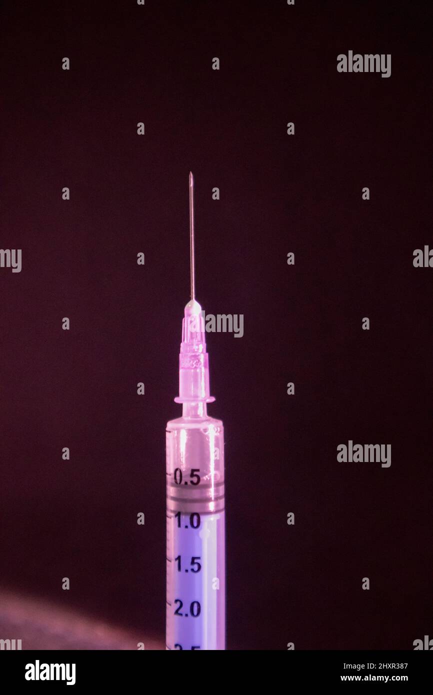 A close-up of a syringe with black background Stock Photo - Alamy