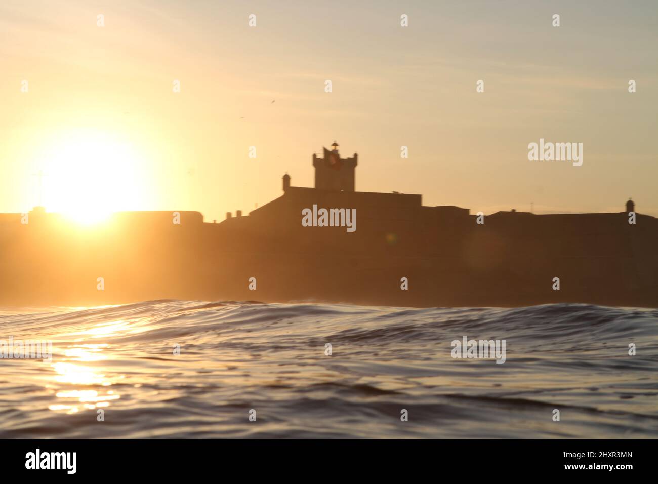 sun rise at Carcavelos beach with Sao Juliao forte as background,Portu ...