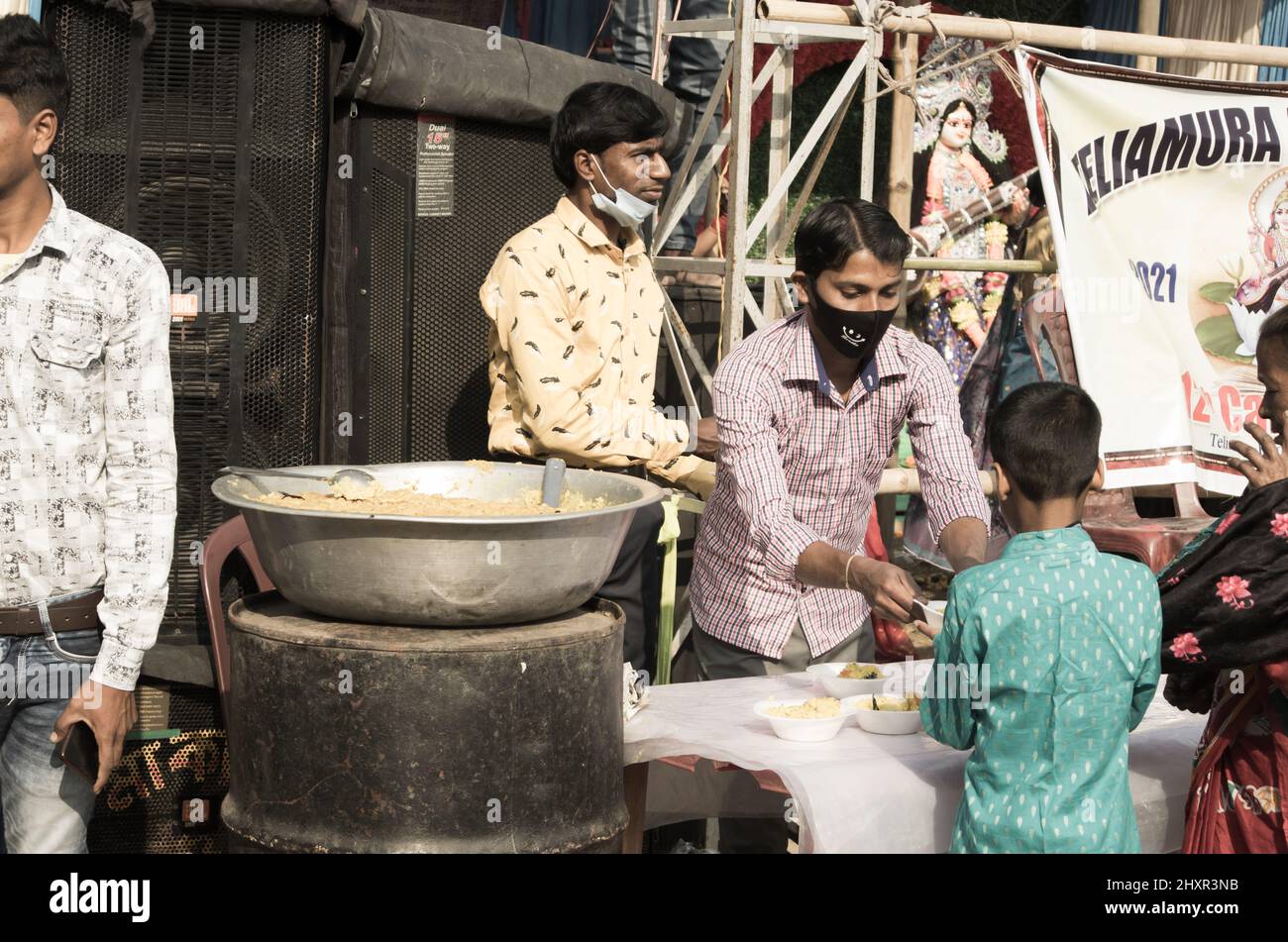 Tripura, India- February 5 2022: Volunteers distributing khichdi prasad ... Tripura, India- February 5 2022: Volunteers distributing khichdi prasad ...