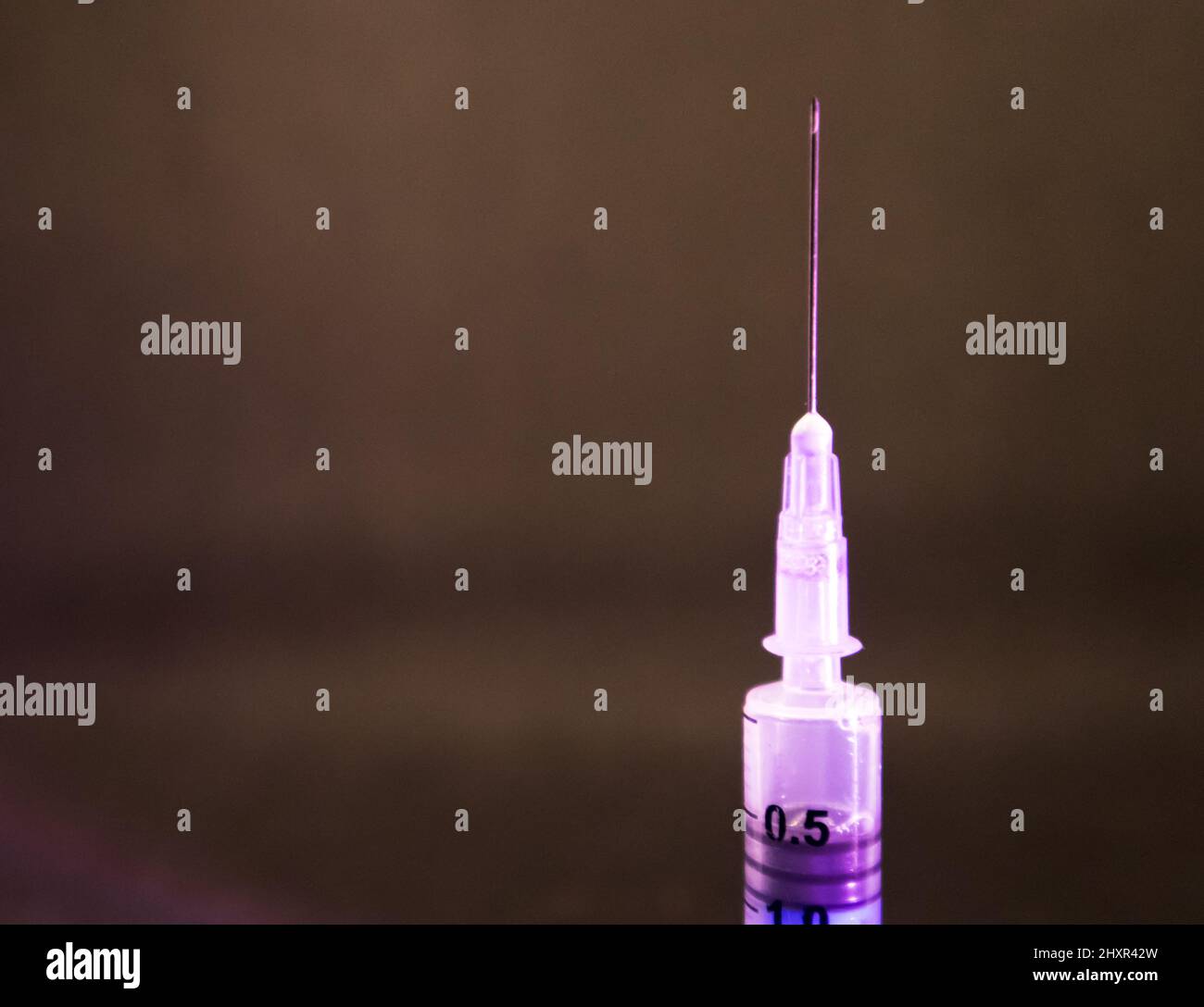 A close-up of a syringe with black background Stock Photo - Alamy