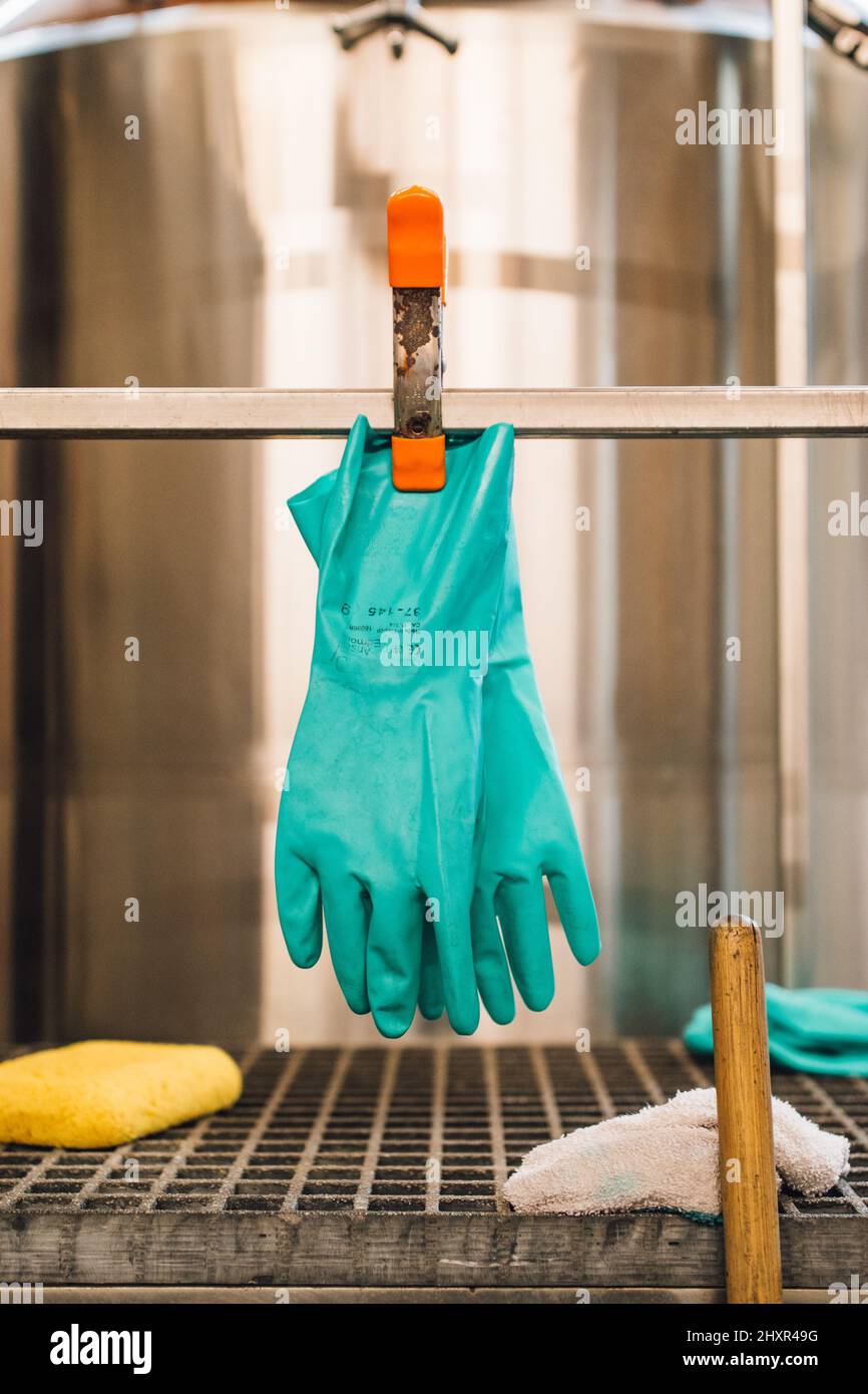 teal turquoise blue rubber gloves in industrial setting Stock Photo - Alamy