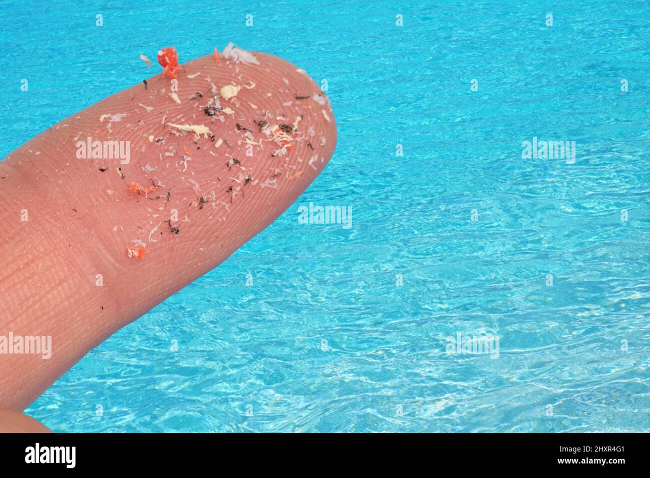 Small Plastic pellets on finger. Micro plastic, problem Stock Photo - Alamy