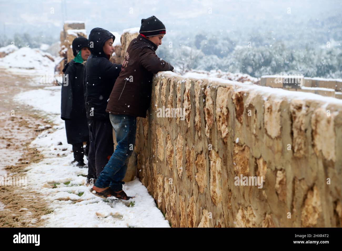 Idlib, Syria 13 March 2022, Children play in the snow in a camp for the ...