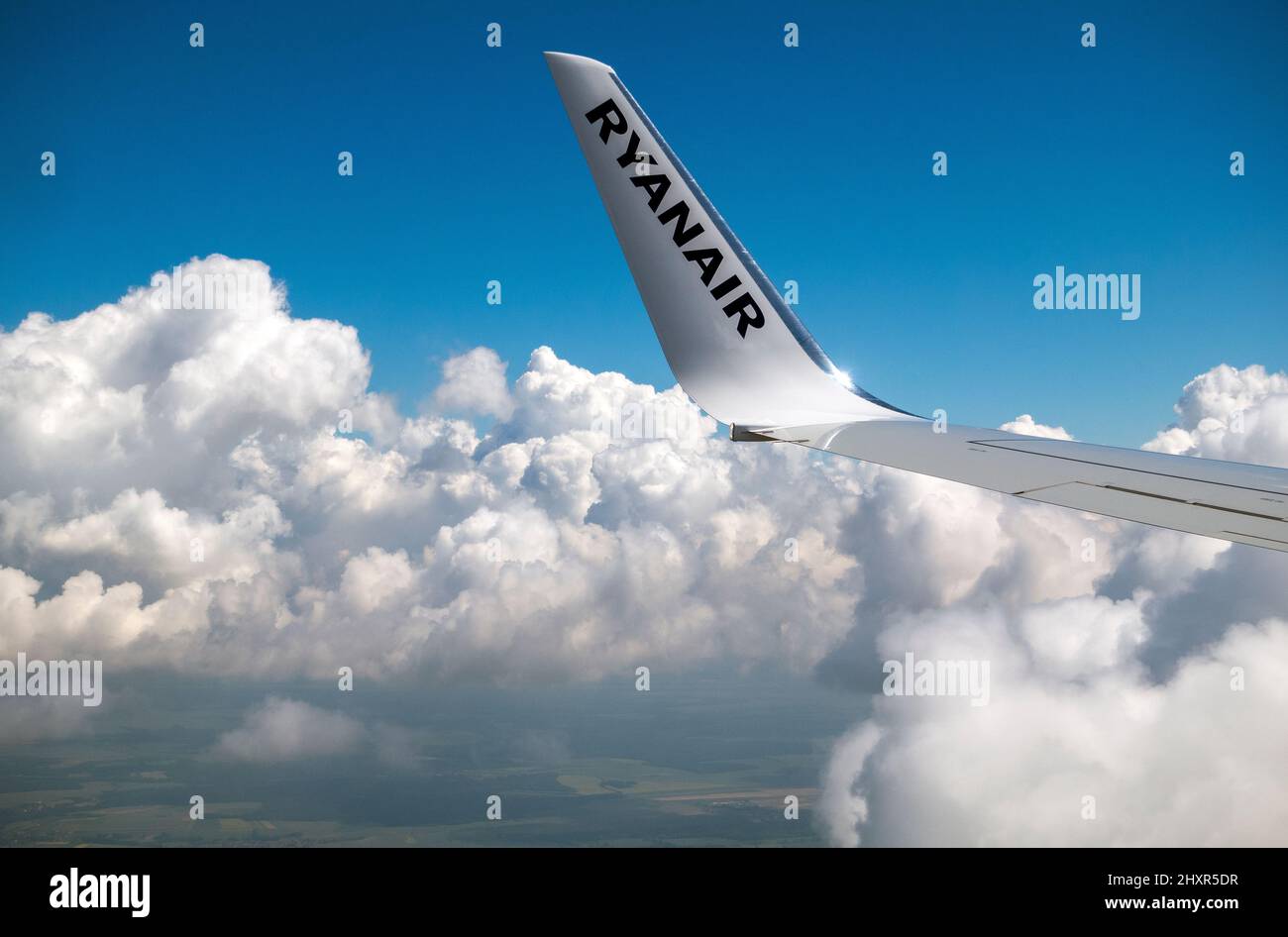 Ryanair aeroplane flying above the clouds showing Ryanair wing tip and ...