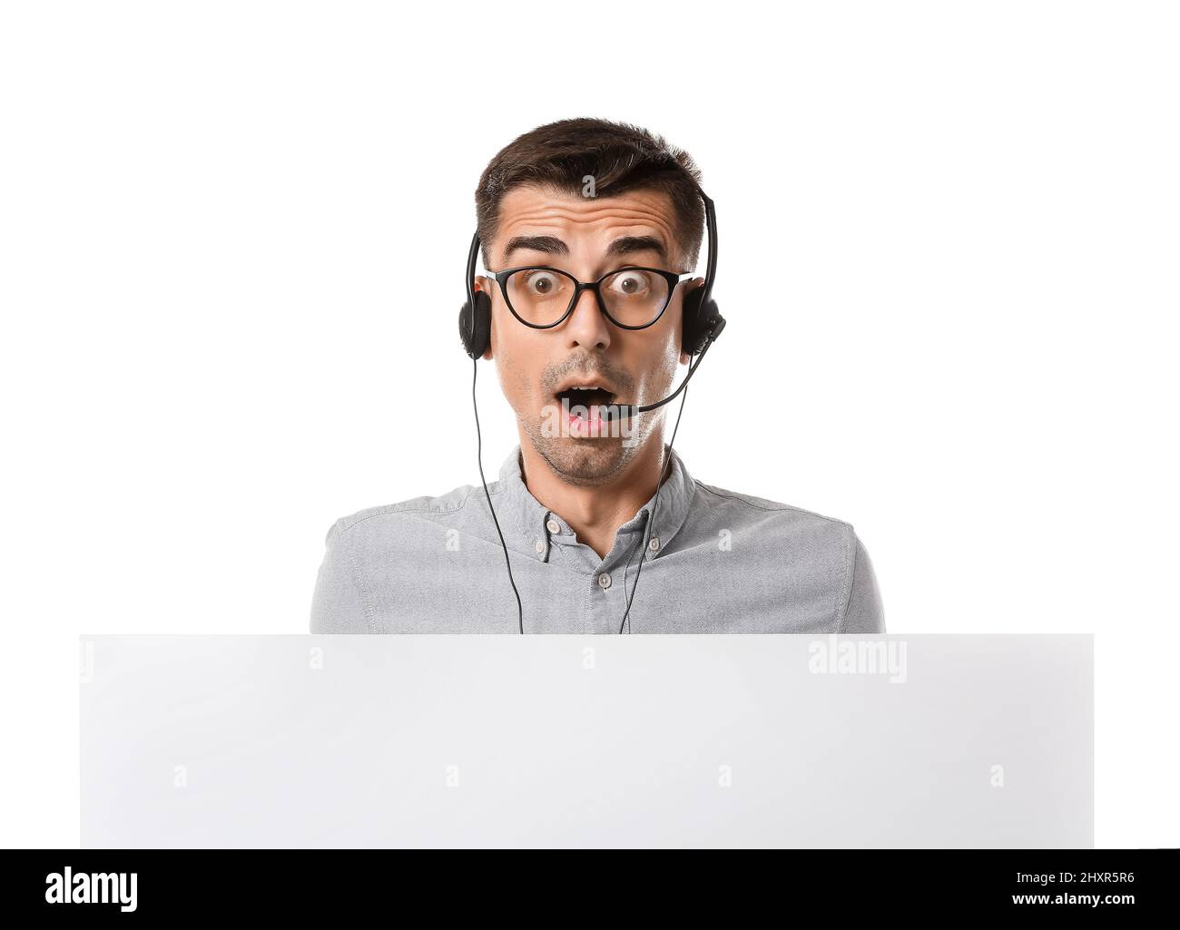 Shocked male consultant of call center in eyeglasses with blank paper ...