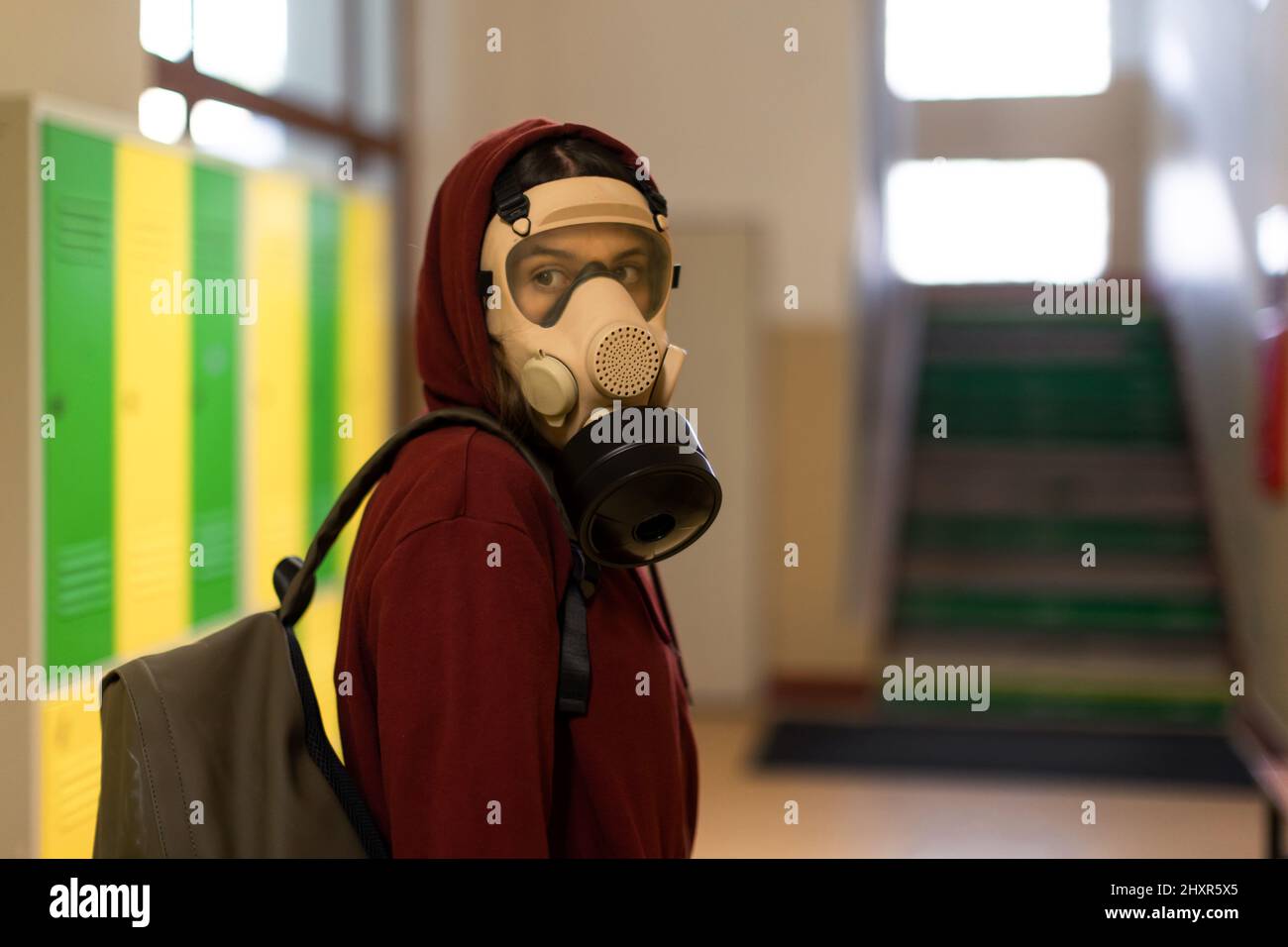Young student in gas mask looking at camera at school Stock Photo - Alamy