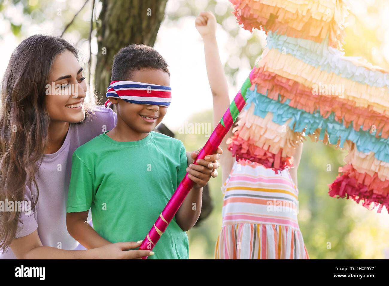 Woman and cute children at pinata birthday party Stock Photo - Alamy