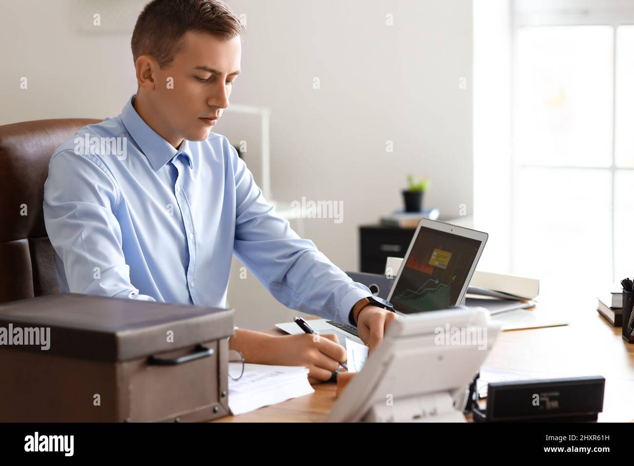 Young male notary public working in office Stock Photo - Alamy