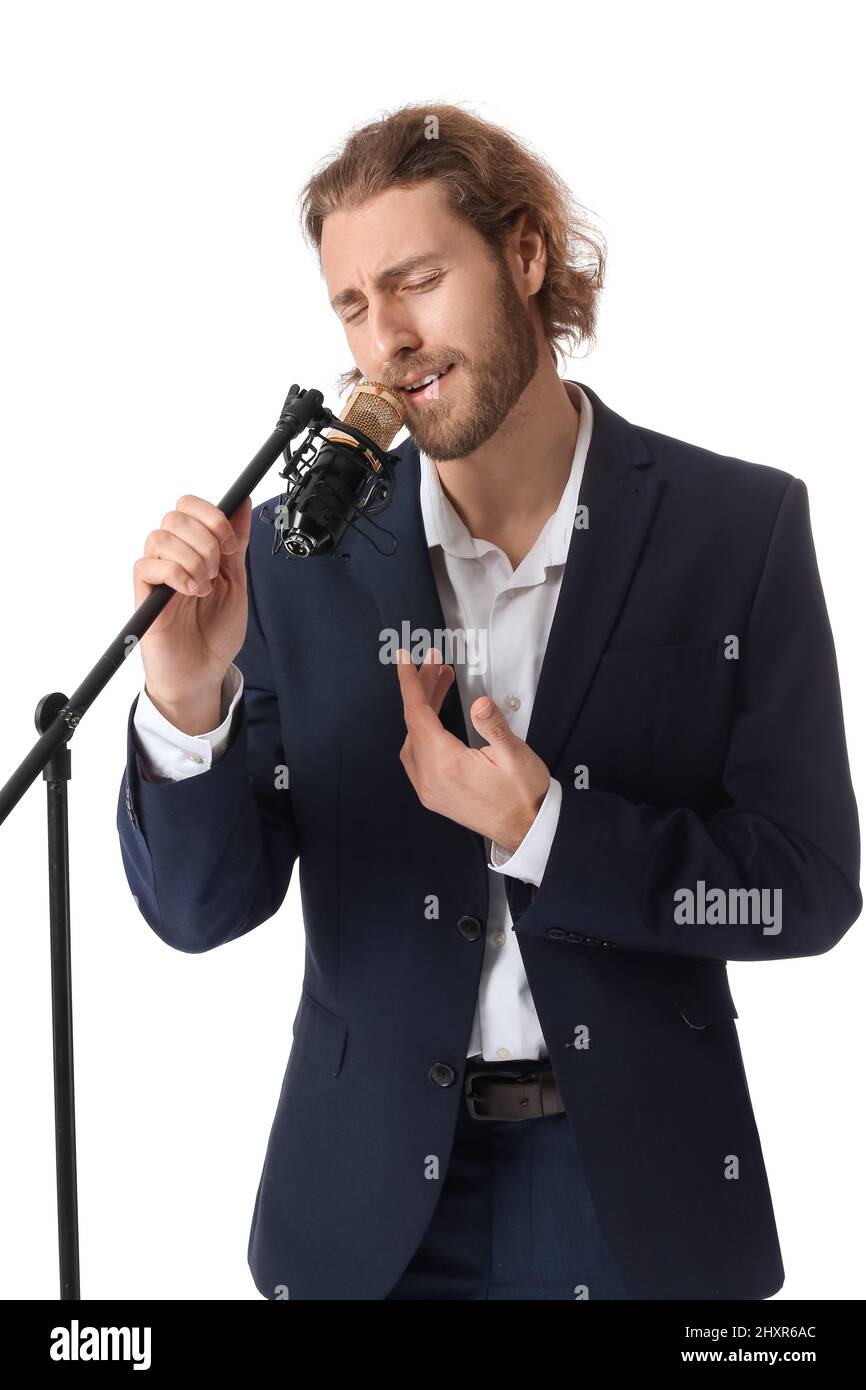 Handsome young man singing in microphone isolated on white Stock Photo ...