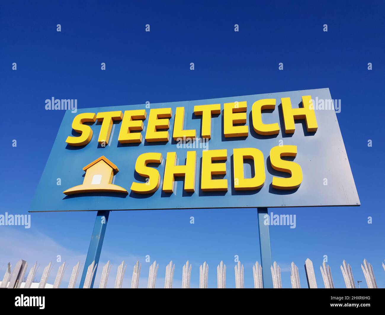 Steeltech Sheds advert under blue sky Stock Photo - Alamy
