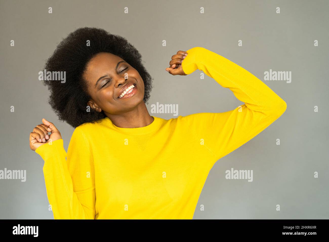 Happy ecstatic black woman scream from excitement hold fists up ...