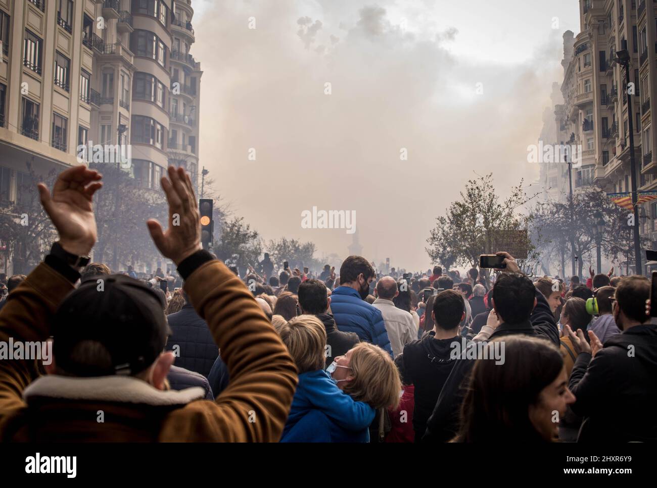 Man Aplauding in the Middle of a Crowd of People who watch the Fallas ...