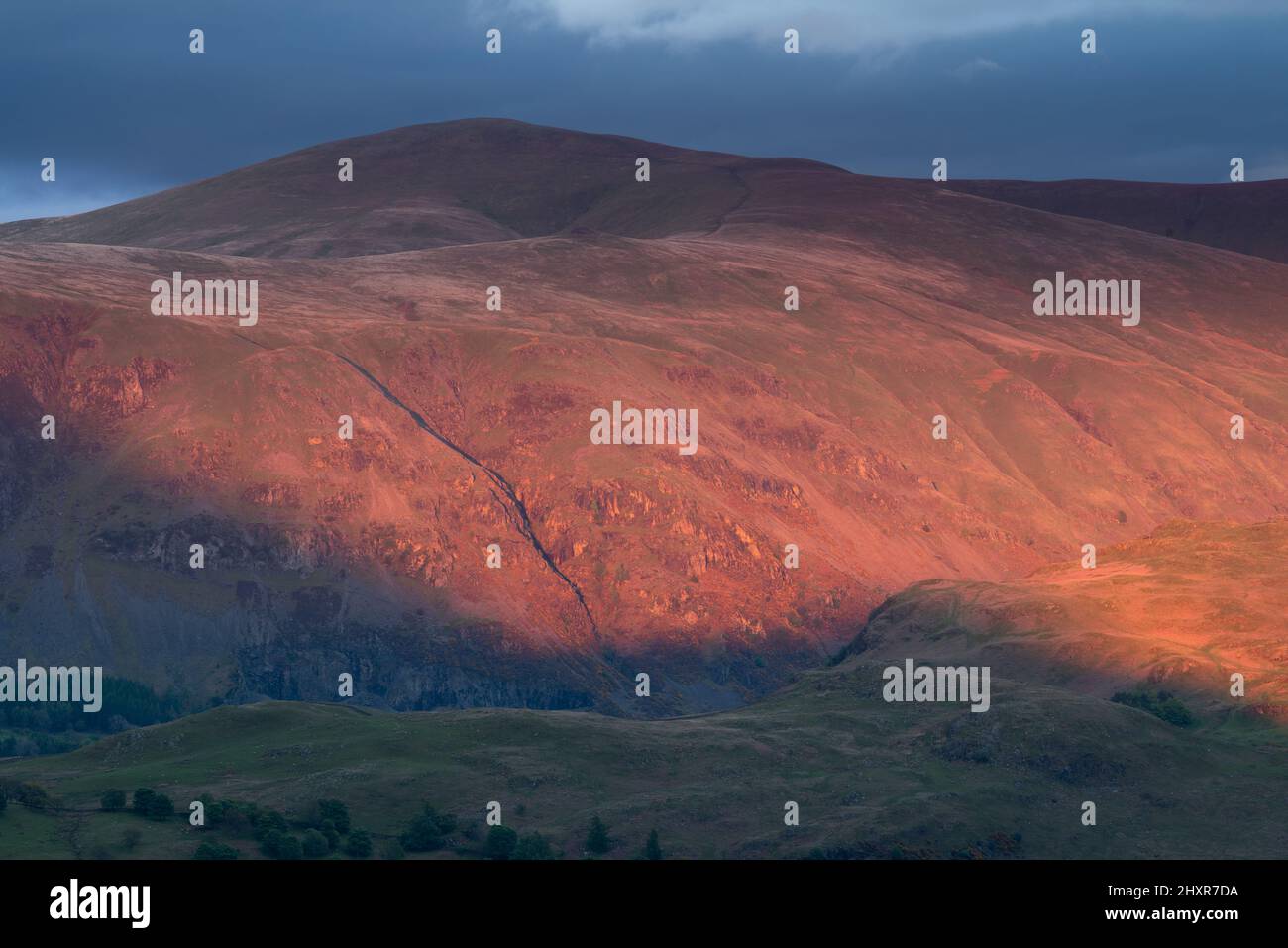 Cumbrian mountain range bathed in dramatic red light. Rugged British ...