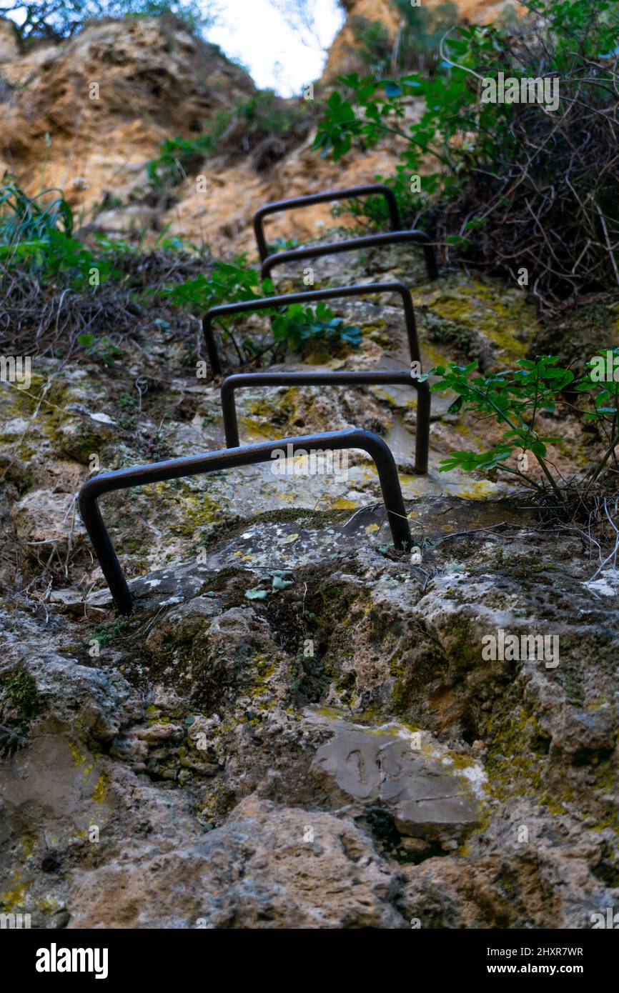 Old metal steps used for climbing leading up a mountain in Ronda, Spain ...
