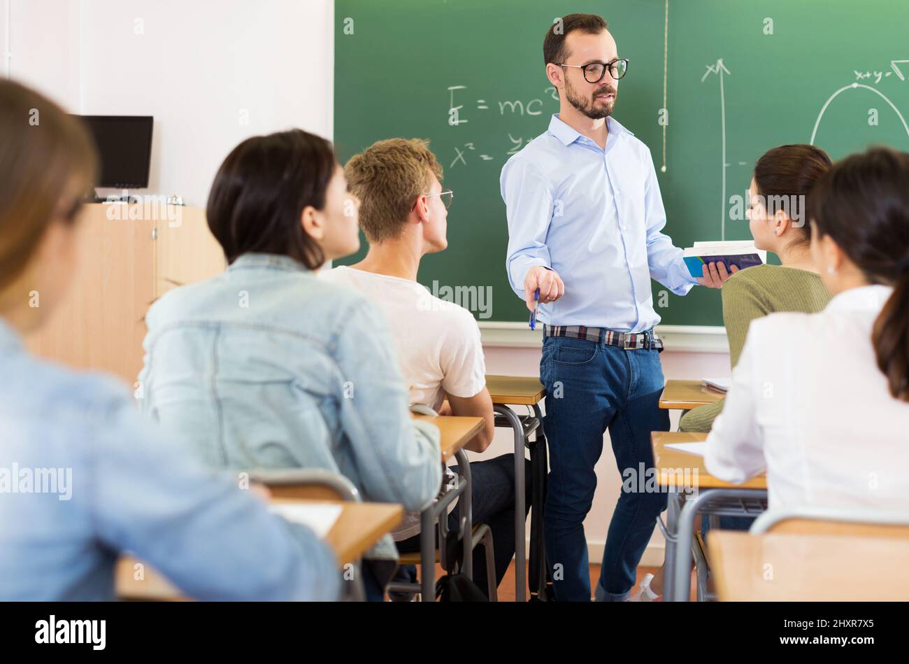 Teacher is giving lecture for students Stock Photo - Alamy