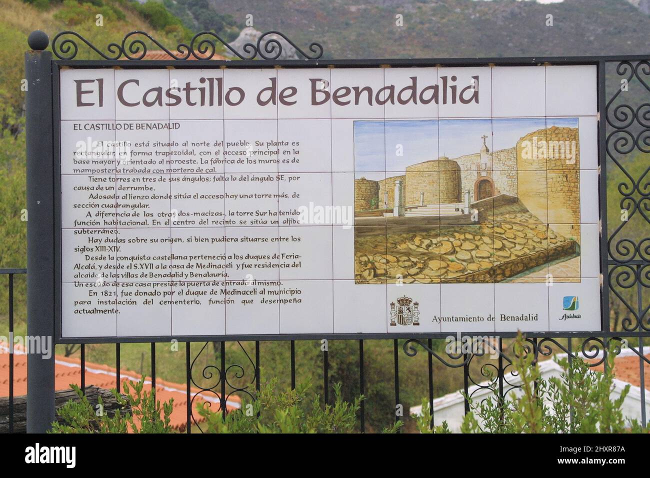 Sign of Castillo de Benadalid - vertical shot of a house with white ...