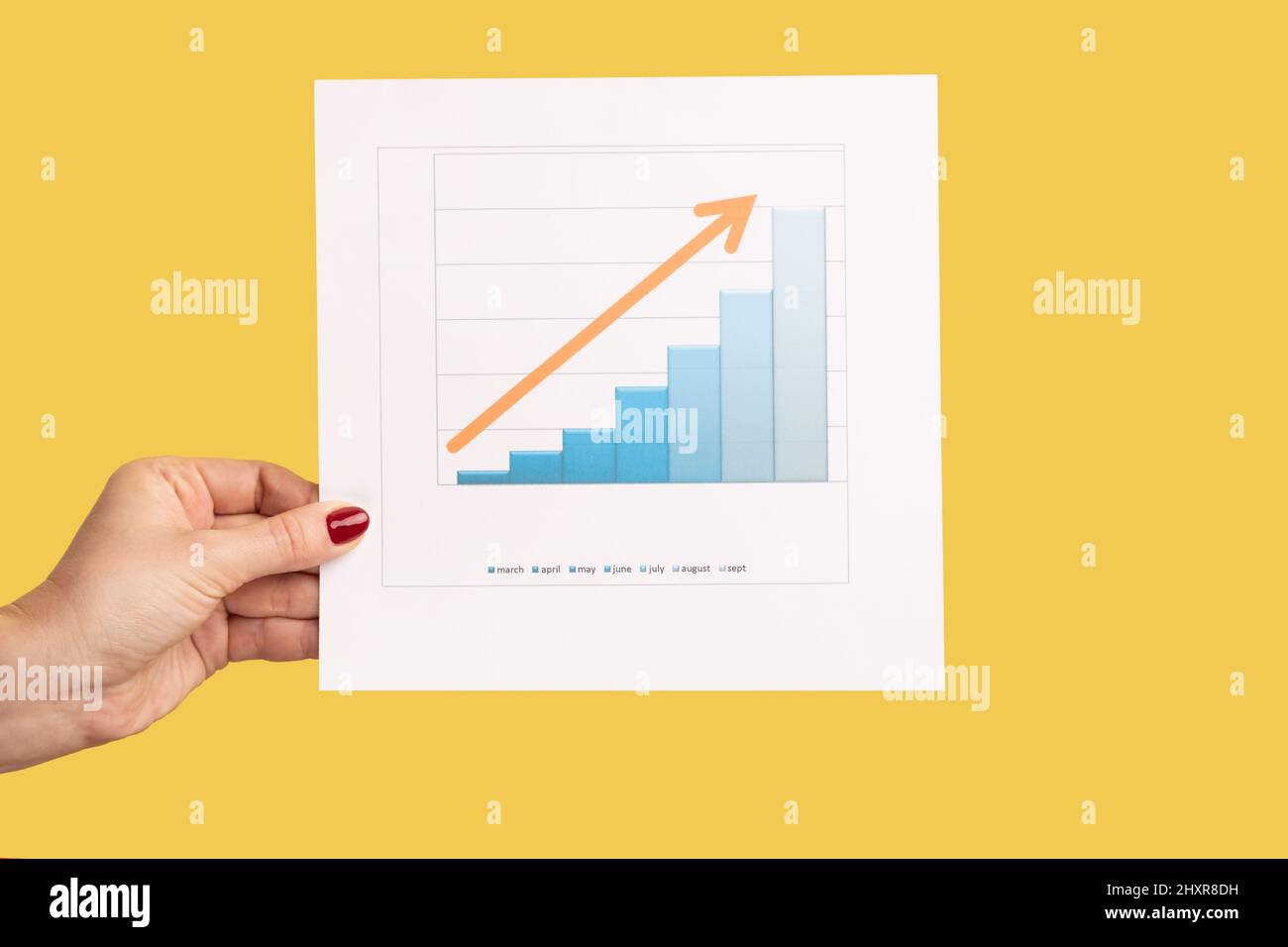 Closeup side view of woman hand holding analyzing graphs and diagrams ...