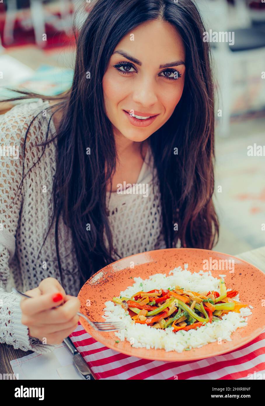 Young woman eating chinese food in a restaurant, having her lunch break ...