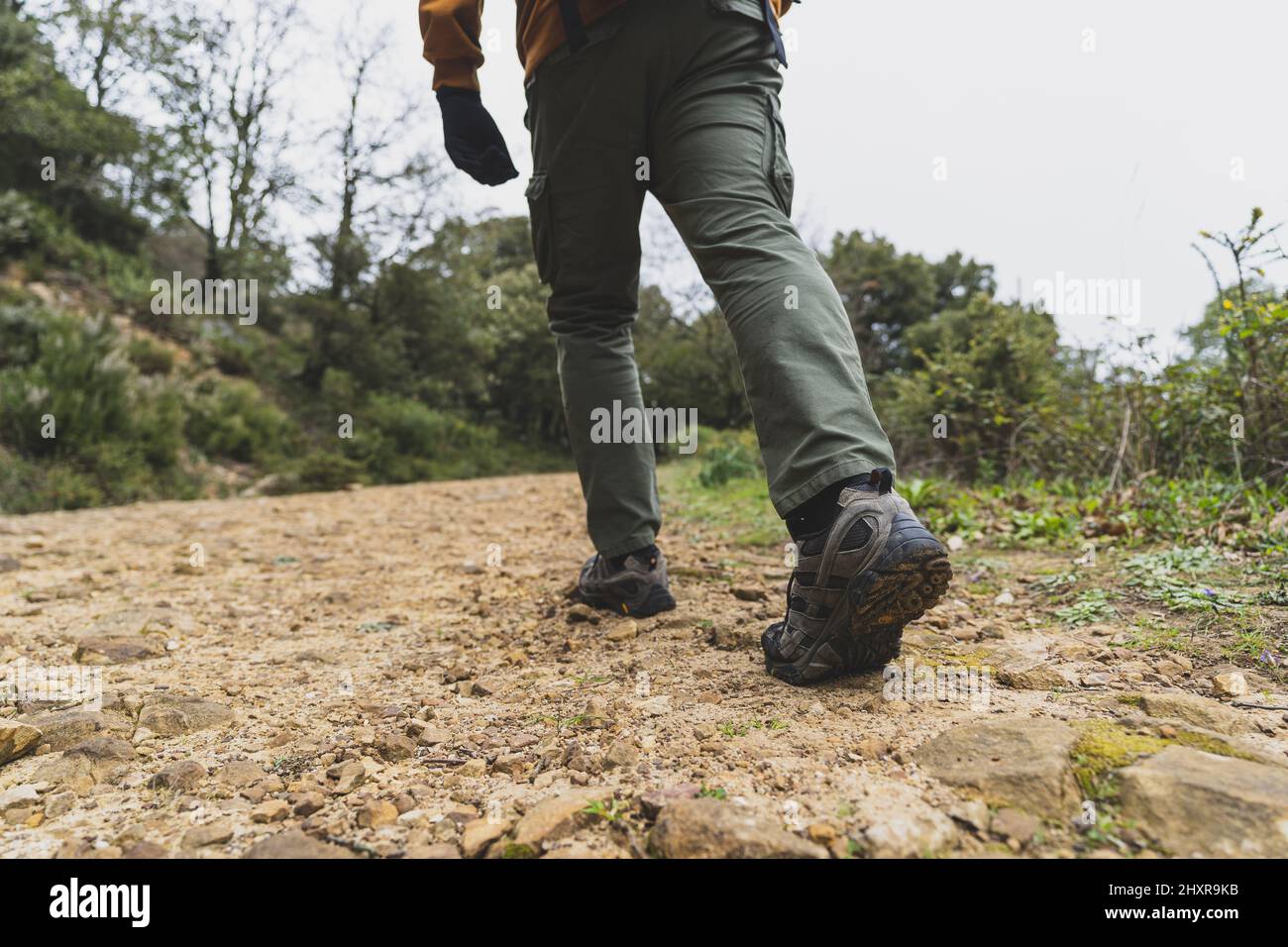 Low angle shot of the feet of the hiker on the ground Stock Photo - Alamy