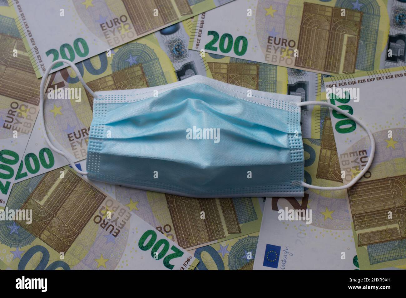 face mask lies on euro banknotes Stock Photo - Alamy