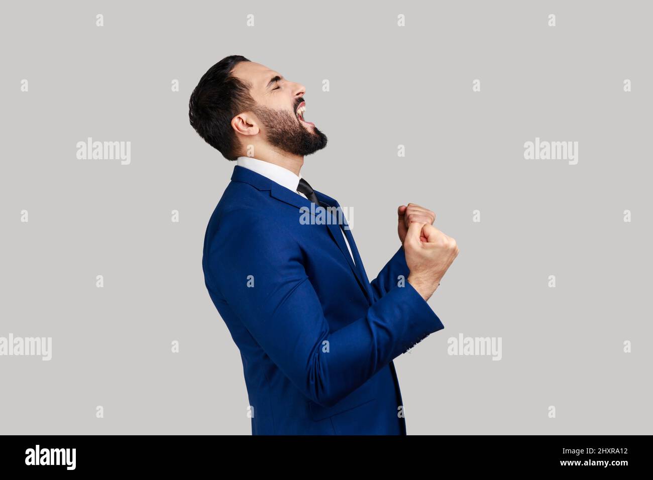 Side view of bearded man showing yes gesture and screaming celebrating ...