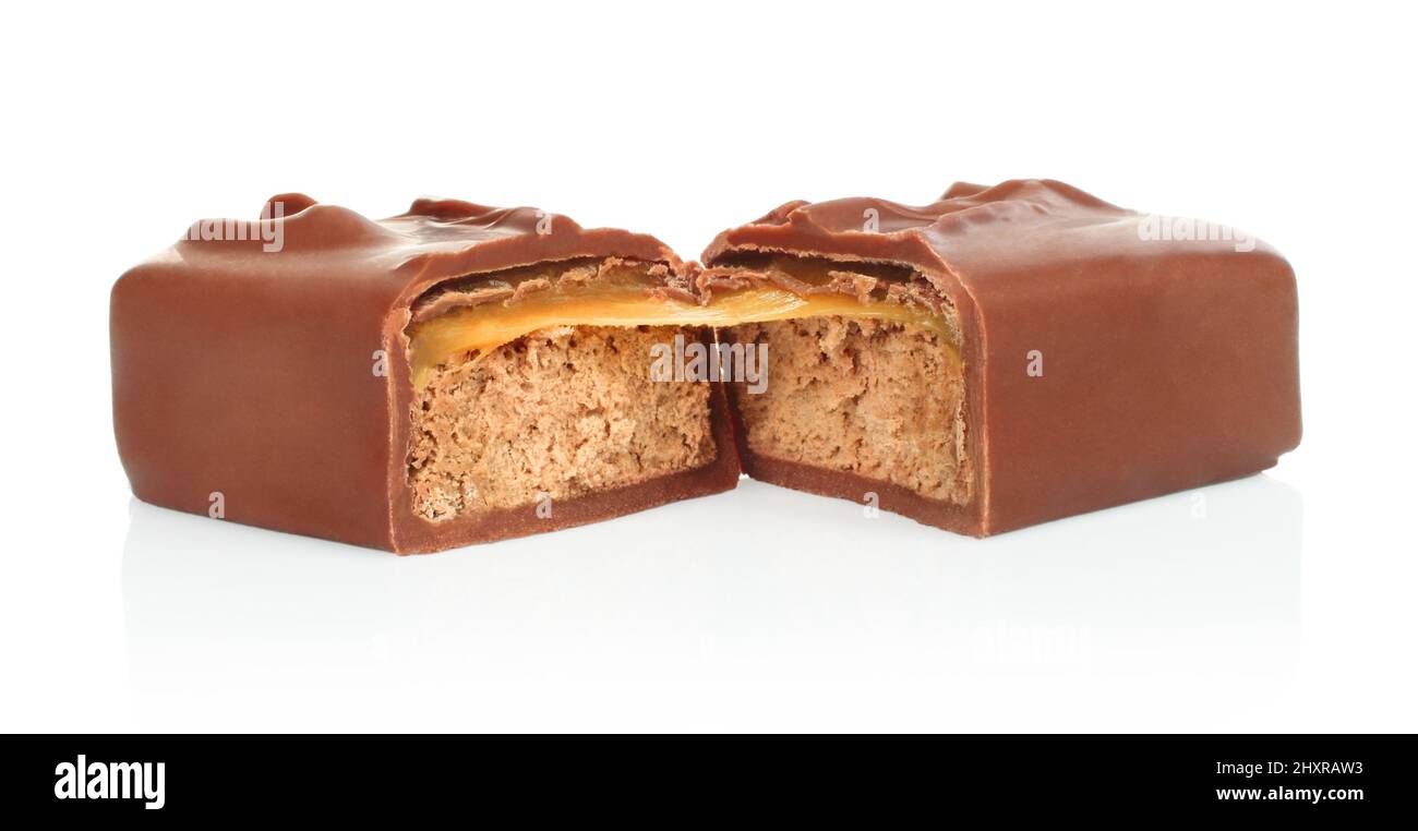 Broken chocolate bar with stretching caramel isolated on white ...