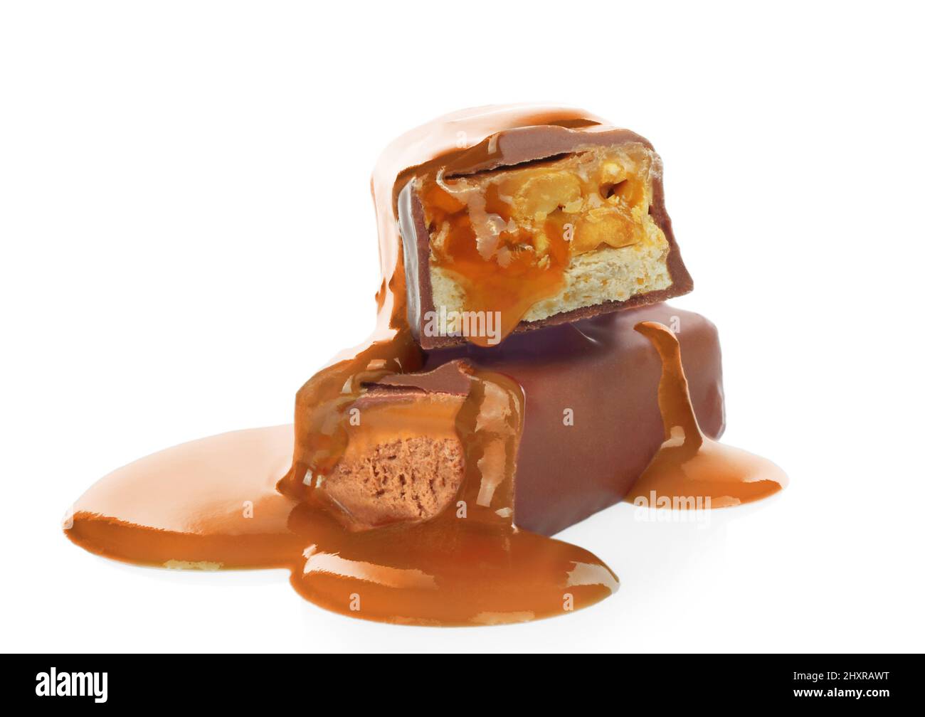 Pouring caramel on broken chocolate bars on white background close-up ...